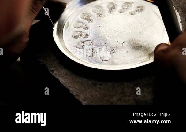 Traditional tinsmith work. Copper smith makes embossing artifacts from ...