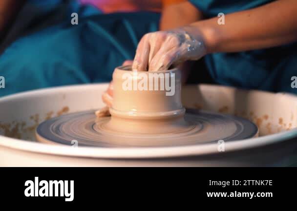 Traditional pottery making, man teacher shows the basics of pottery in ...