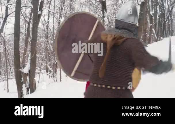 Medieval frankish and viking warriors in armor fighting in a winter ...