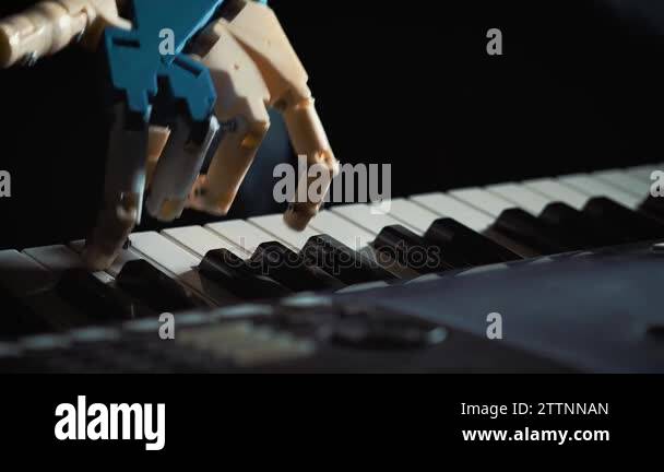 man musician pianist with a prosthetic hand playing the piano. He plays ...