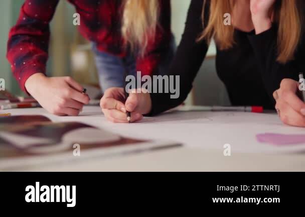 Closeup view of hands of young creative people drawing a draft with ...