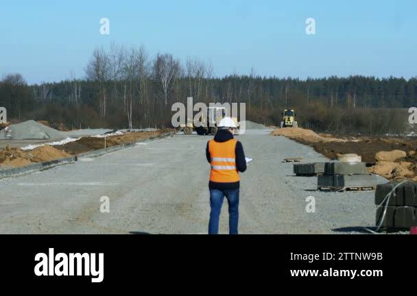 Surveyor or chief inspects and writes information during a stage of ...