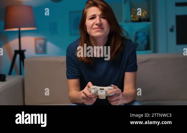 Sad girl loses the video game at home at night. Excited gamer woman ...