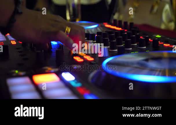 Close up of dj playing party music on modern cd usb player in disco ...