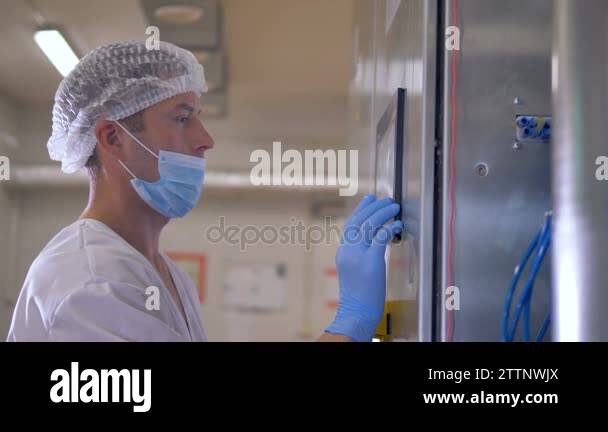 Employee operating industrial equipment. Factory worker operates ...