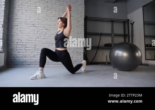 Yoga mat young athletic woman stretching hip, hamstring muscles, leg ...