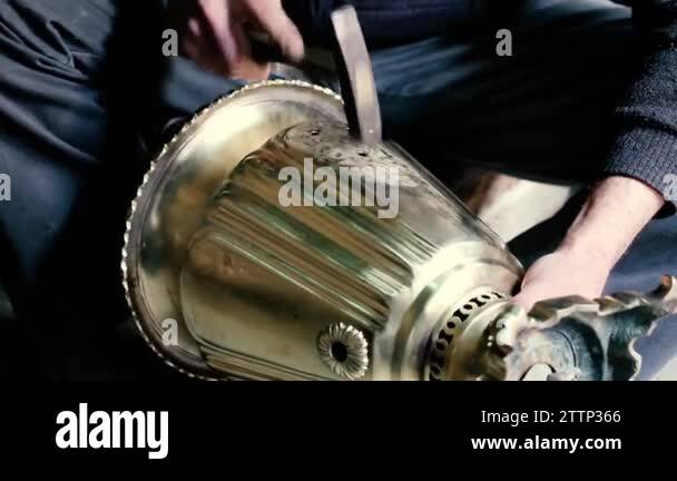 Traditional tinsmith work. Copper smith makes embossing artifacts from ...