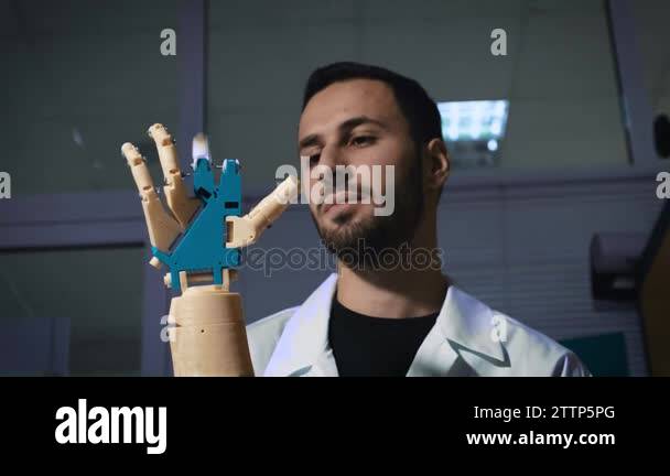 male engineer scientist experiences a bionic prosthesis of a mechanical ...