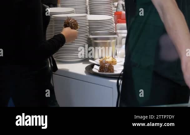 Fast food Cafe at work. Waiters behind the counter, work process ...