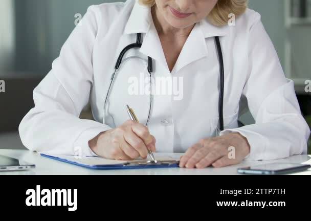 Female physician prescribing medication at clinic, professional doctor ...