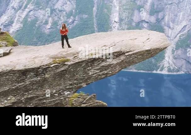 Odda, Norway. Young Girl Woman Makes A Gymnastic Exercise Standing On A ...
