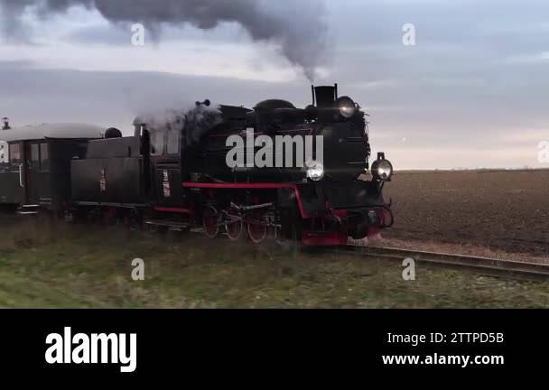 Old passangers train running on the tracks. Retro locomotive with steam ...