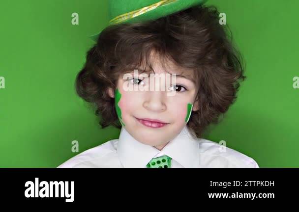 Child Celebrating St. Patrick's Day looking at the camera. A small ...