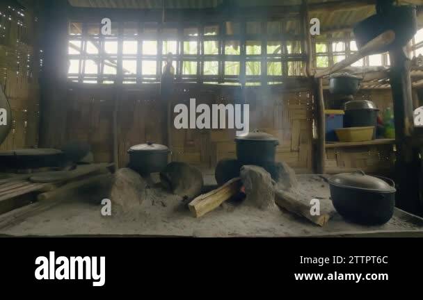 Food cooking on fire in kitchen inside traditional bamboo house in ...