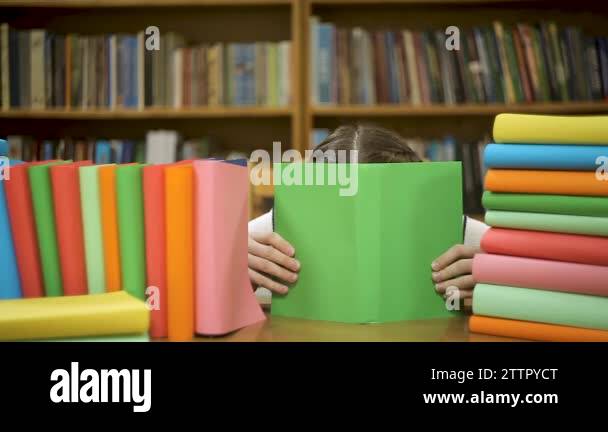 Girl hiding book Stock Videos & Footage - HD and 4K Video Clips - Alamy