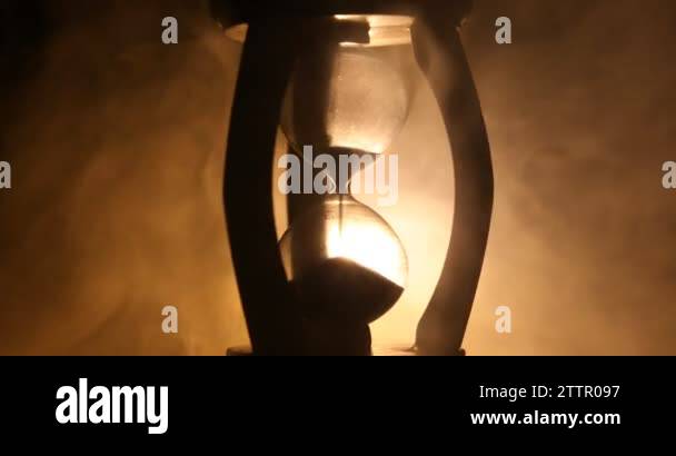 Time concept. Silhouette of Hourglass clock rotating in smoke on dark ...