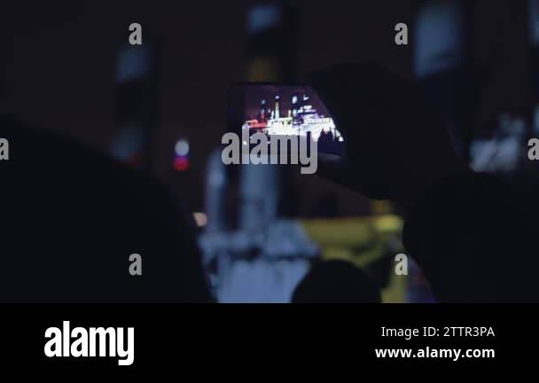People shoots 3D mapping light show on a mobile phone Stock Video ...