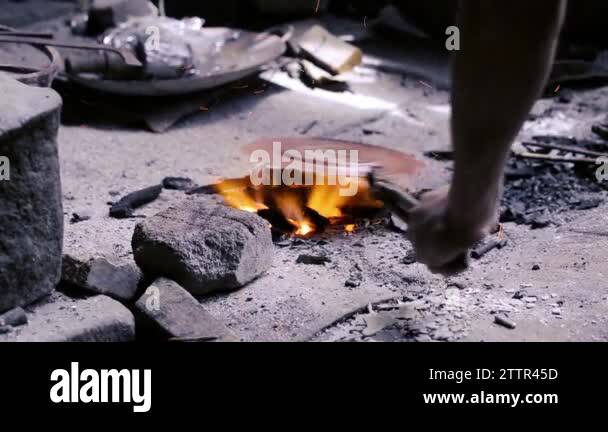 Traditional tinsmith work. Copper smith makes embossing artifacts from ...