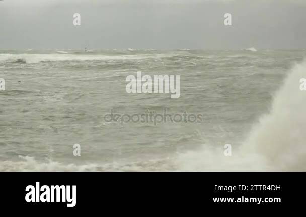 The wave breaks down on a concrete slab on the shore Stock Video ...