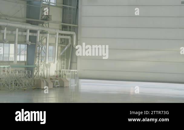 Hangar for aircraft with large open gate at sunny summer day. Gates ...
