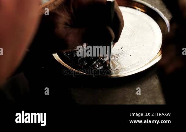 Traditional tinsmith work. Copper smith makes embossing artifacts from ...