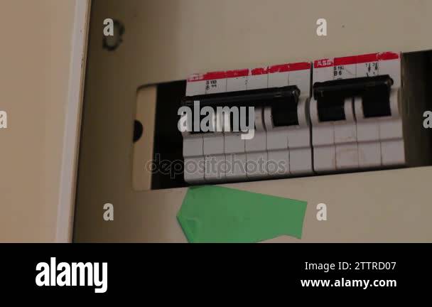 Female hand toggle switch in the switch box, All switches being turned ...