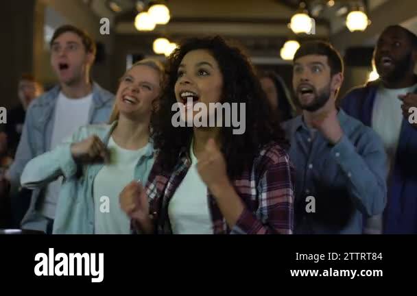 Positive sport fans cheering, clapping hands together and shouting ...