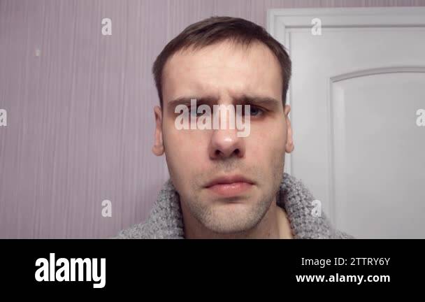 A man changes a serious expression on a stupid and surprised with ...