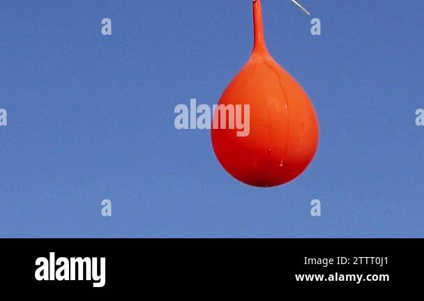 Explosion of balloon full of water on sky background, Full HD video ...