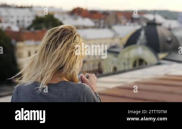 Drunk Woman Drinks Alcohol On Rooftopwind Blowing Her Hair Stock Video Footage Alamy