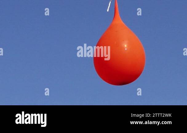 Explosion of balloon full of water on sky background, Full HD video ...