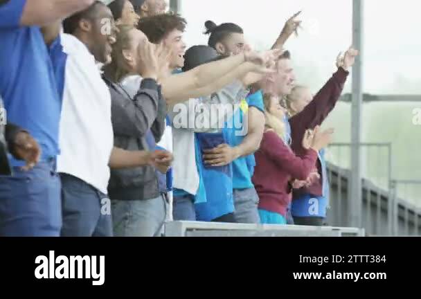 4K Excited sports fans at live event clapping and cheering for their ...