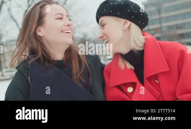 Two young girls in a city enjoying time. Positive face expressions ...