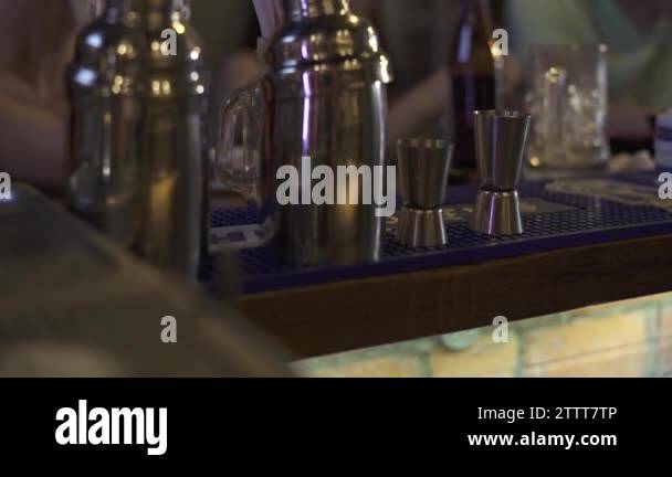 Cocktail shaker and beaker for preparation beverages on bar counter in ...