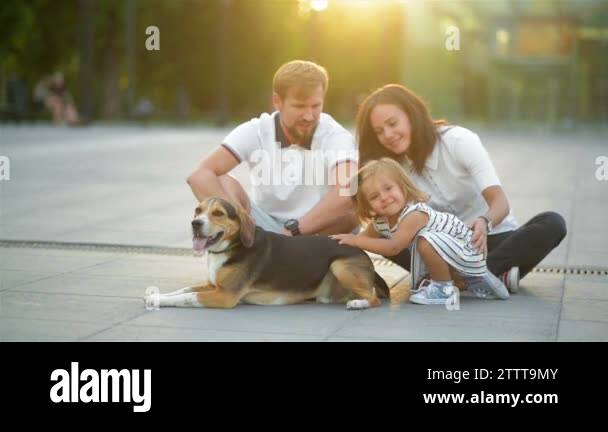 Lovely Family Hugging Each Other Sitting on the Ground During Summer ...