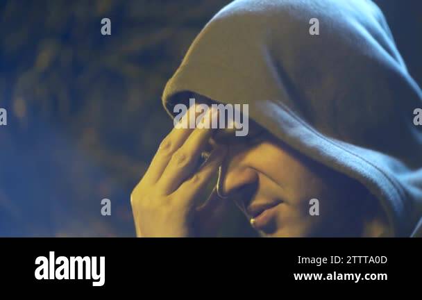 Profile of a sad man with a hood. close-up, background blur, bokeh. 4k ...