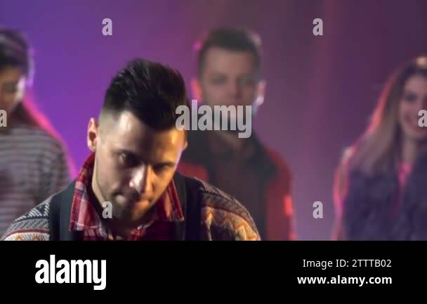 Group people dancing with raised arms to the music in smoky club . Slow ...