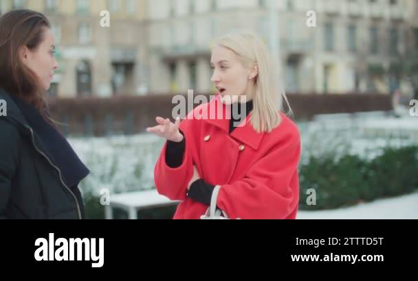 Two young girls in a city enjoying time. Positive face expressions ...