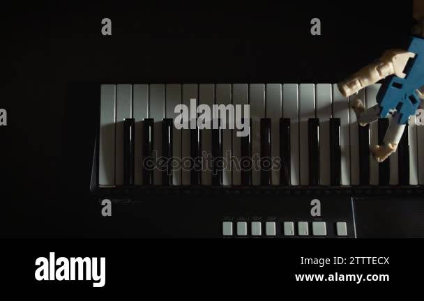 Robot plays a musical instrument. man musician pianist with a ...