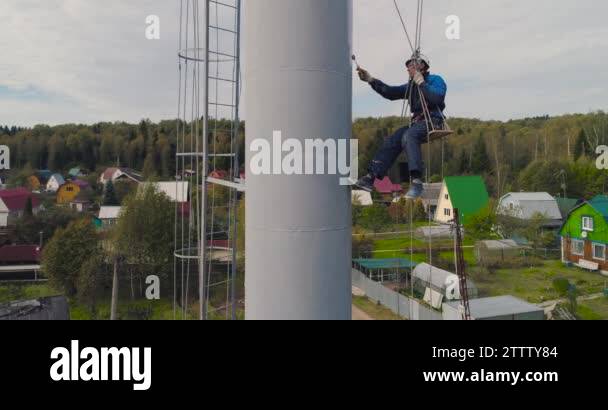 industrial climbers paint the iron tower. Risky job. Extreme work ...