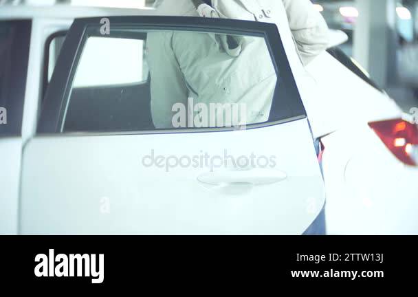 a man puts things in the car and sits behind the wheel. 4k Stock Video ...