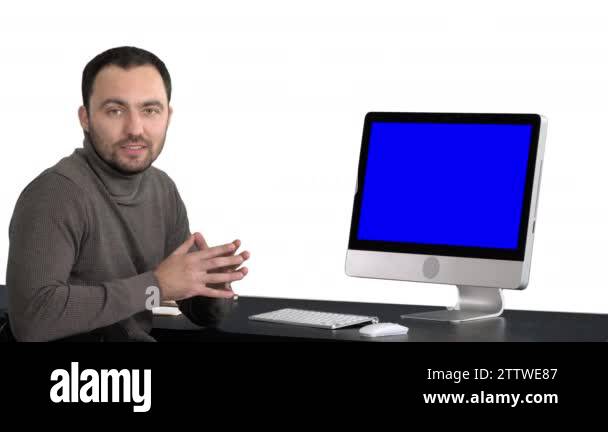 Casual businessman smiling and talking at the camera showing something ...