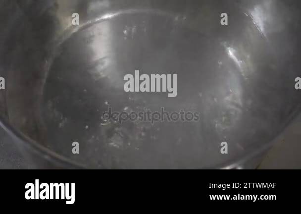 Boiling water in pan on electric stove in the kitchen of restaraunt. in ...