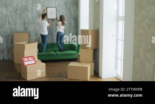 Young happy millennial couple students move into their first new owners ...