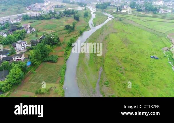 Aerial view, green rice and vegetable fields in poor village in China ...