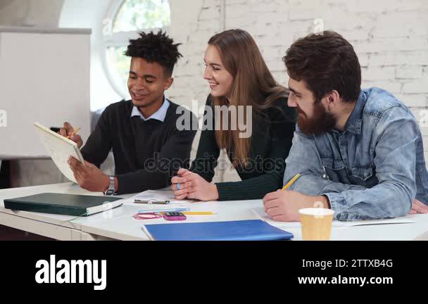 Multiethnic group of people working together. Young african guy ...