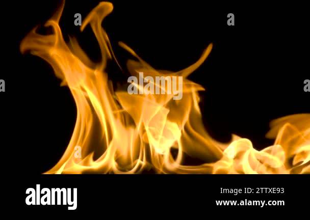 Fire and flames burning on a reflective glass surface, in slow motion ...