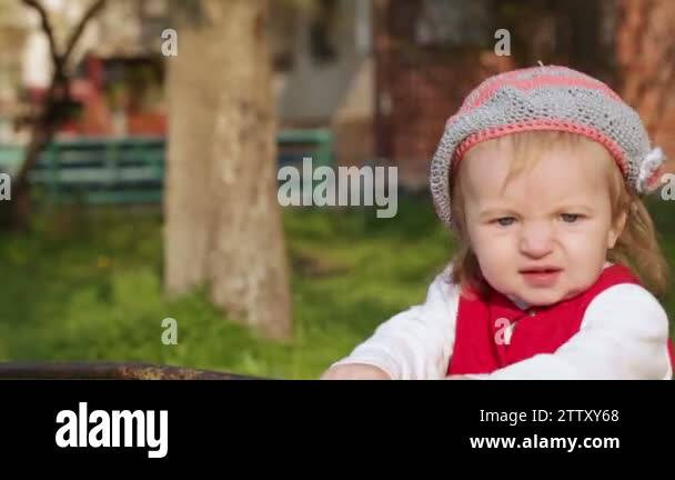 Little girl standing near fence Stock Video Footage - Alamy