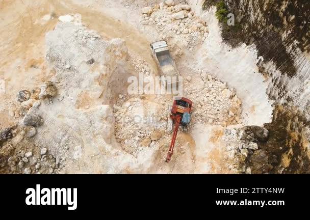 Excavator loads truck in quarry. Philippines,Siargao Stock Video ...