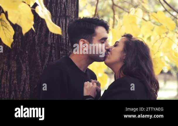 love, romance, kissing- young couple under a tree kisses tenderly Stock Video Footage - Alamy